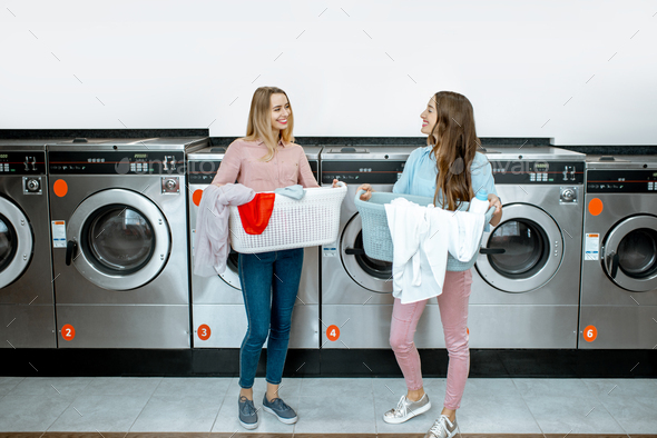 Women with clothes at the laundry Stock Photo by RossHelen | PhotoDune