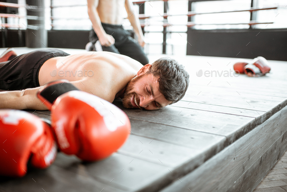 Boxer falling on the floor during a boxing battle Stock Photo by RossHelen