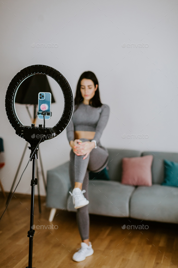 Virtual online fitness. Woman virtual workout at home living room Stock ...