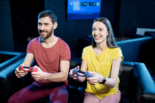 Couple playing video games with gaming console in the club Stock Photo ...