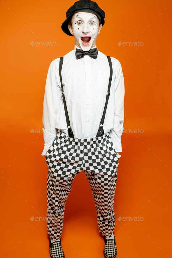 Pantomime on the orange background Stock Photo by RossHelen | PhotoDune