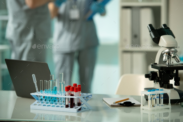 Desk of laboratory researcher Stock Photo by Pressmaster | PhotoDune