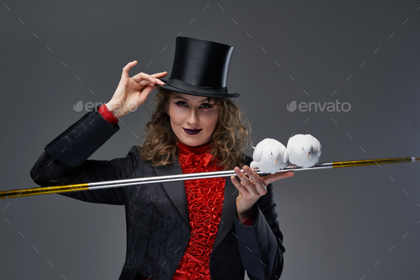 Beautiful woman from circus showing tricks with stick and doves Stock ...