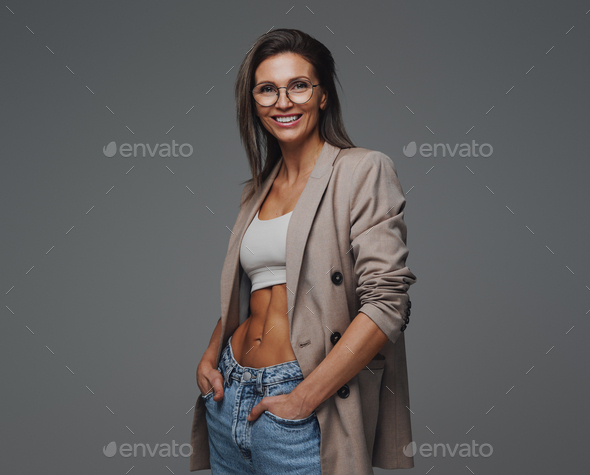 Muscular and elegant female sportsperson with glasses in studio Stock ...