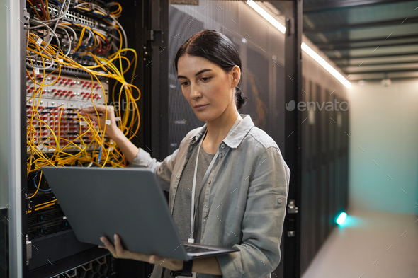 Female Network Technician Inspecting Servers in Data Center Stock Photo ...