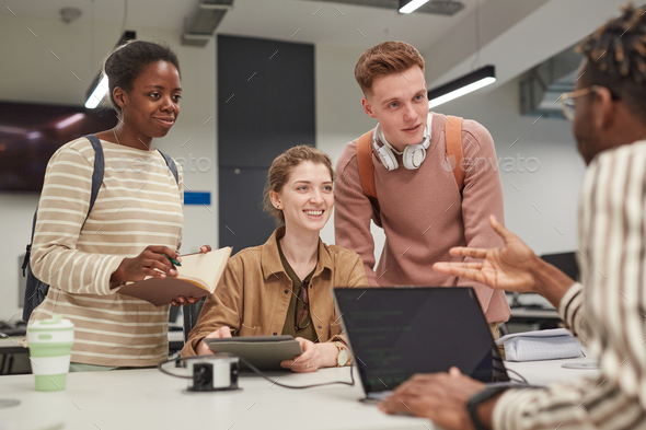 Cheerful Group of Students Working at Table Stock Photo by ...