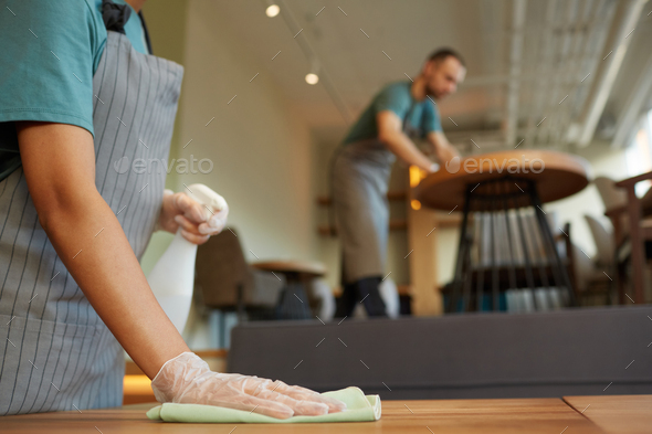 Waitress Cleaning Table Stock Photo by seventyfourimages | PhotoDune