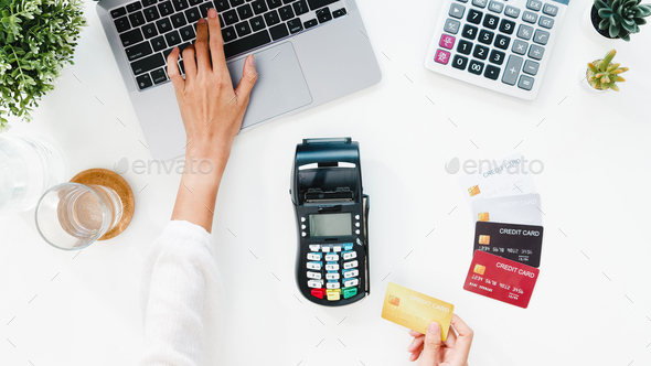 Asia lady using laptop online shopping with credit card pay the bill by ...