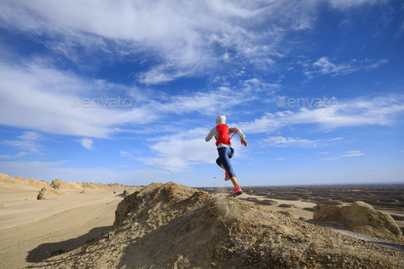 Woman trail runner cross country running on sand desert dunes Stock ...