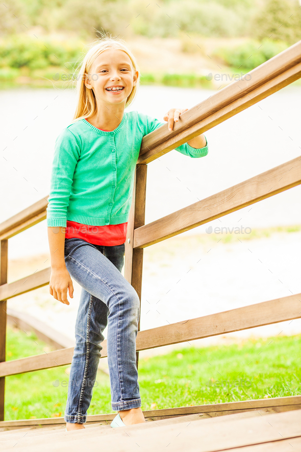 Cute little girl. Top view of cute little girl moving up by outdoor ...
