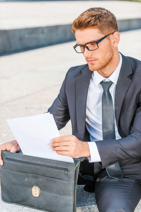 Looking for the right document. Stock Photo by gstockstudio | PhotoDune