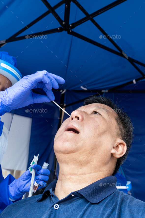 Mature asian man doing covid 19 PCR nasal swab test via nostril Stock ...