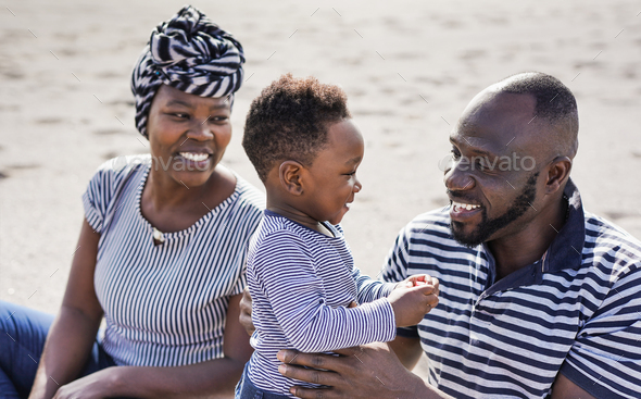 African parents having playful time with little son outdoor - Black ...