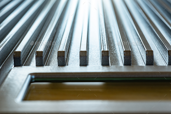 Fluted metal surface next to a control panel Stock Photo by YouraPechkin