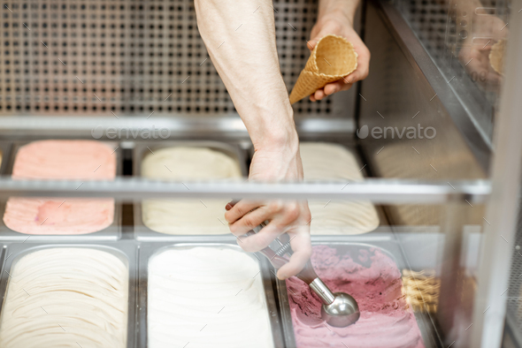 Taking ice cream from the showcase Stock Photo by RossHelen | PhotoDune