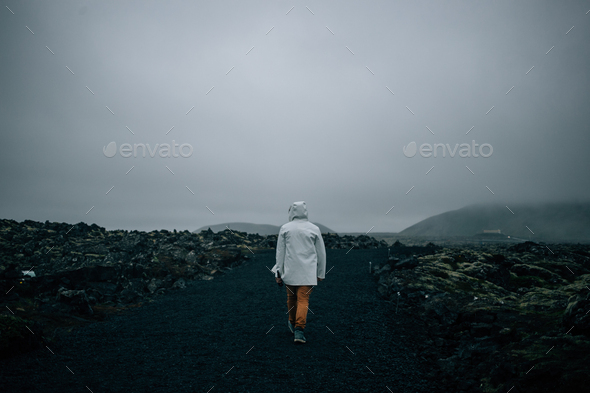 Adventure man walk in icelandic landscape alone Stock Photo by bublikhaus