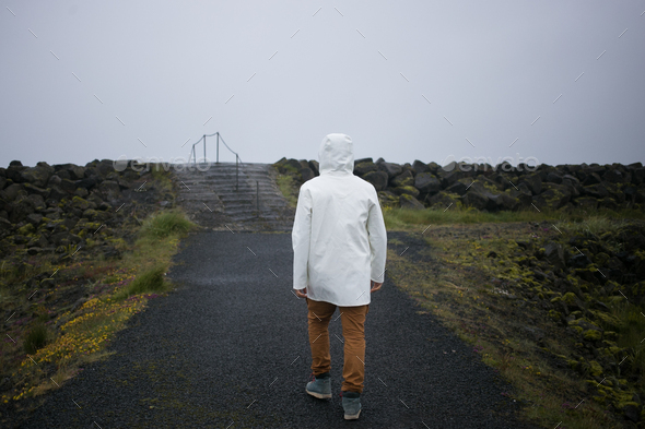 Adventure man walk in icelandic landscape alone Stock Photo by bublikhaus