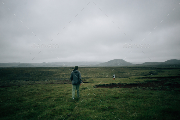 Adventure man walk in icelandic landscape alone Stock Photo by bublikhaus