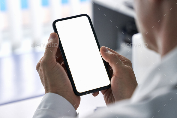 Male doctor holding cell phone using white screen ehealth mobile app ...