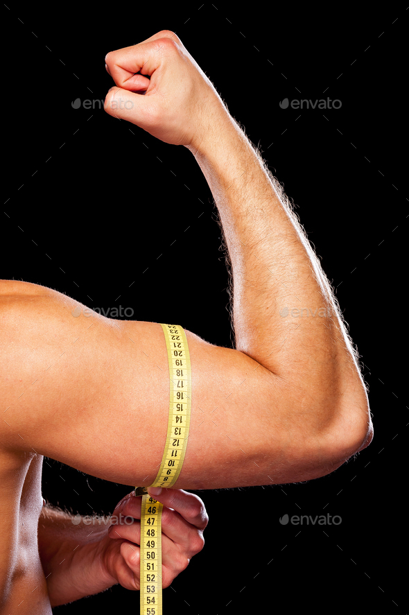 Measuring his perfect bicep. Stock Photo by gstockstudio | PhotoDune