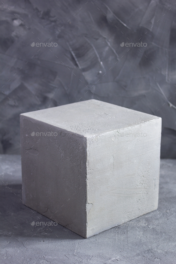 Concrete cube or construction brick near wall background texture ...