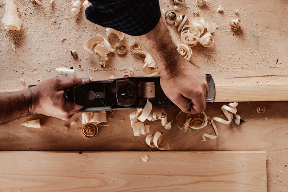 Carpenter's hands planing a plank of wood with a hand plane Stock Photo ...