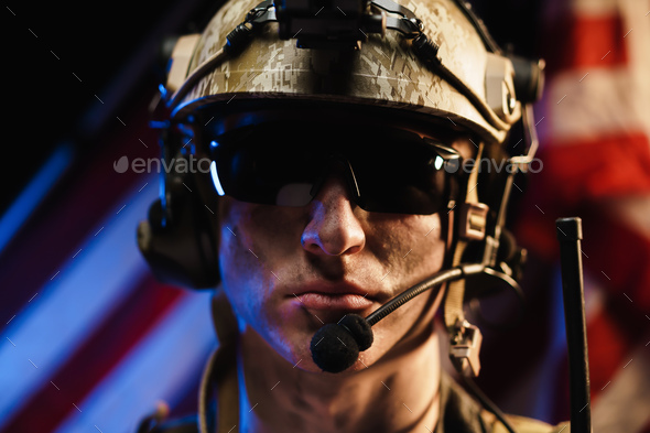 Portrait of special forces soldier in glasses and helmet against US ...