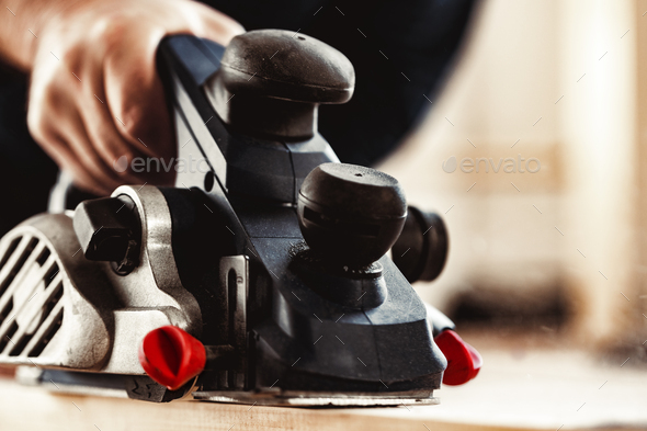 Carpenter's hands working with electric planer in a workshop Stock ...
