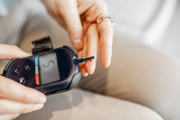 Measuring the level of blood glucose with glucometer Stock Photo by ...