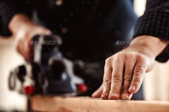 Carpenter's hands working with electric planer in a workshop Stock ...