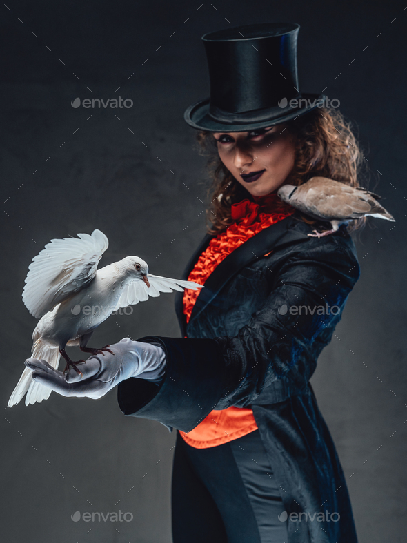 Eccentric woman with doves posing in dark background Stock Photo by ...