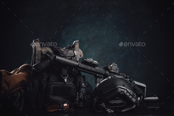 Militray equipment and weapons on a table in dark background Stock ...