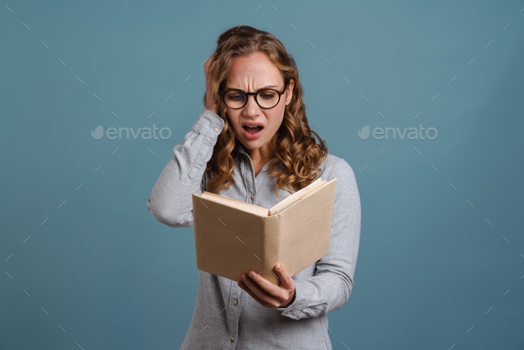 Shocked young woman reading a book Stock Photo by vadymvdrobot | PhotoDune