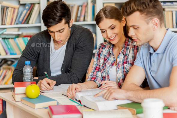 Preparing for exams in library. Stock Photo by gstockstudio | PhotoDune