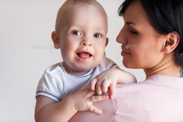 Mother and baby. Rear view of mother holding her smiling baby Stock ...