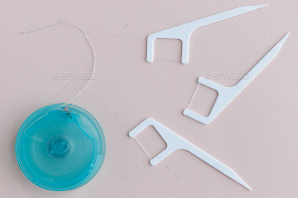 dental floss in box and disposable plastic toothpick with dental floss ...