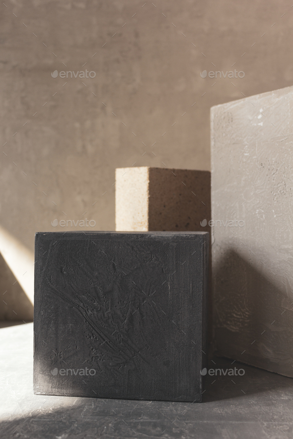 Concrete cube and bricks near wall background texture. Abstract art or ...