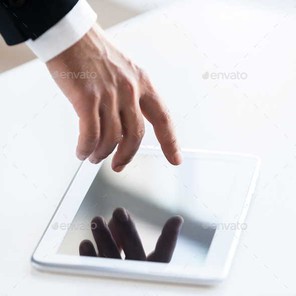 Join a digital age! Top view of human hand touching a screen of digital ...