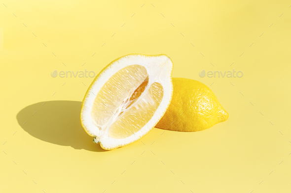 Two halved cuts of lemon with shadow on yellow background Stock Photo ...
