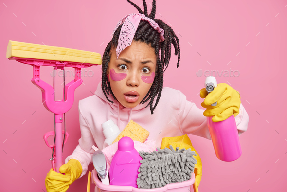 Housekeeping duties concept. Surprised dark skinned woman with ...