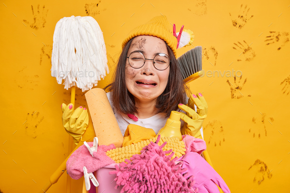 Stressed young Asian woman cries from despair has doleful expression ...