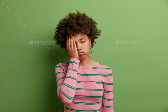 Horizontal shot of frustrated African American woman has tired ...