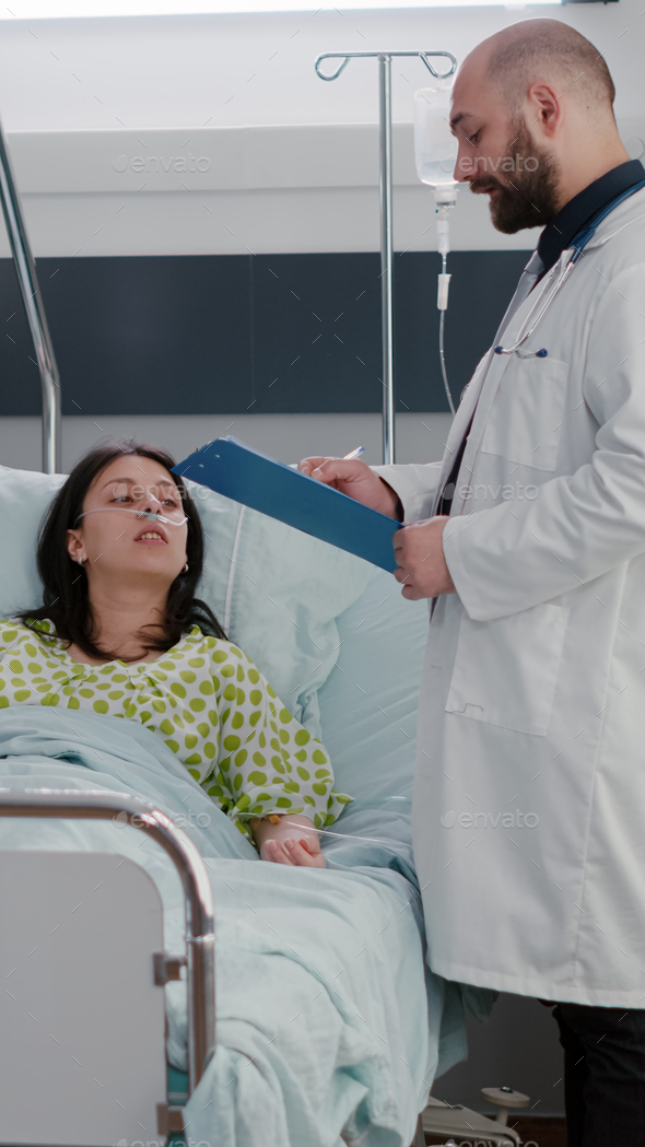 Practitioners doctors monitoring sick woman writing sickness treatment ...