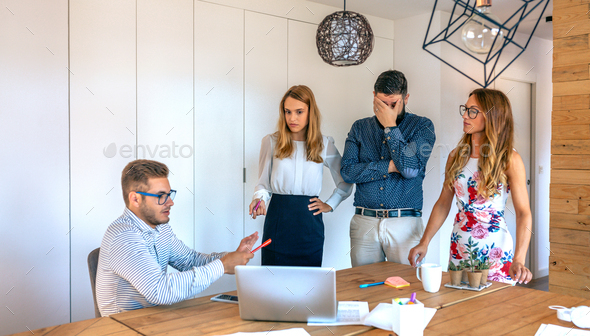 Management team scolding an incompetent worker at the office Stock ...