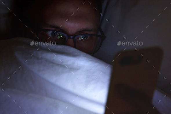man surfing on internet with smartphone late at night Stock Photo by ...