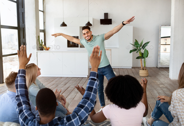 Funny young diverse friends playing guess who game, laughing, having ...