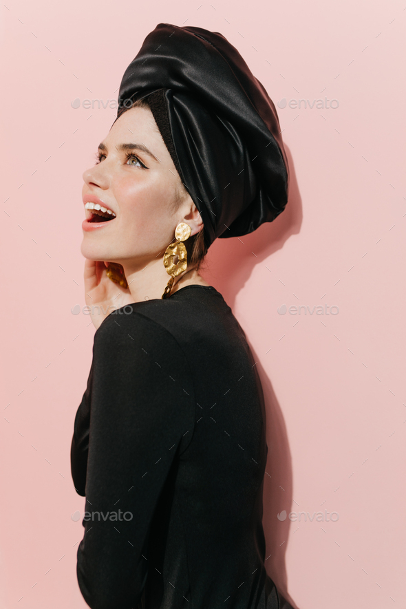 Laughing pretty girl posing in turban and golden earrings. Studio shot ...