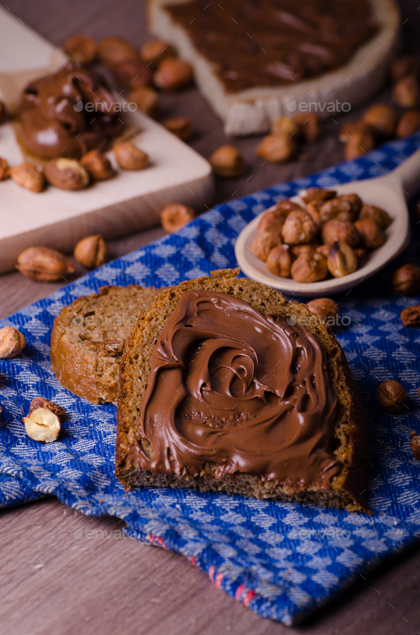 Healthy bread with Chocolate spread and nuts Stock Photo by PeteerS