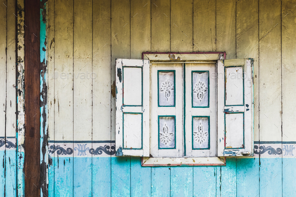 Old vintage wooden window with shutters and curtains on traditional ...