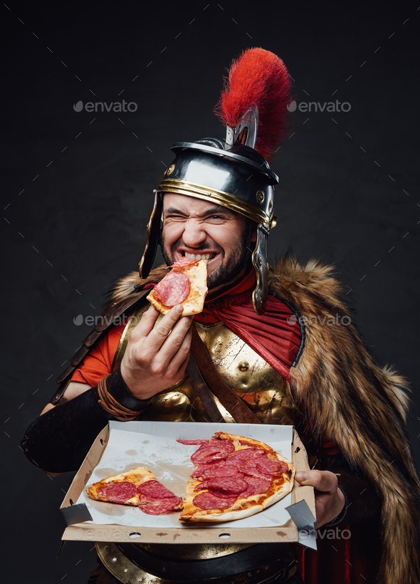 Angry ancient rome warrior with pizza against dark background Stock ...